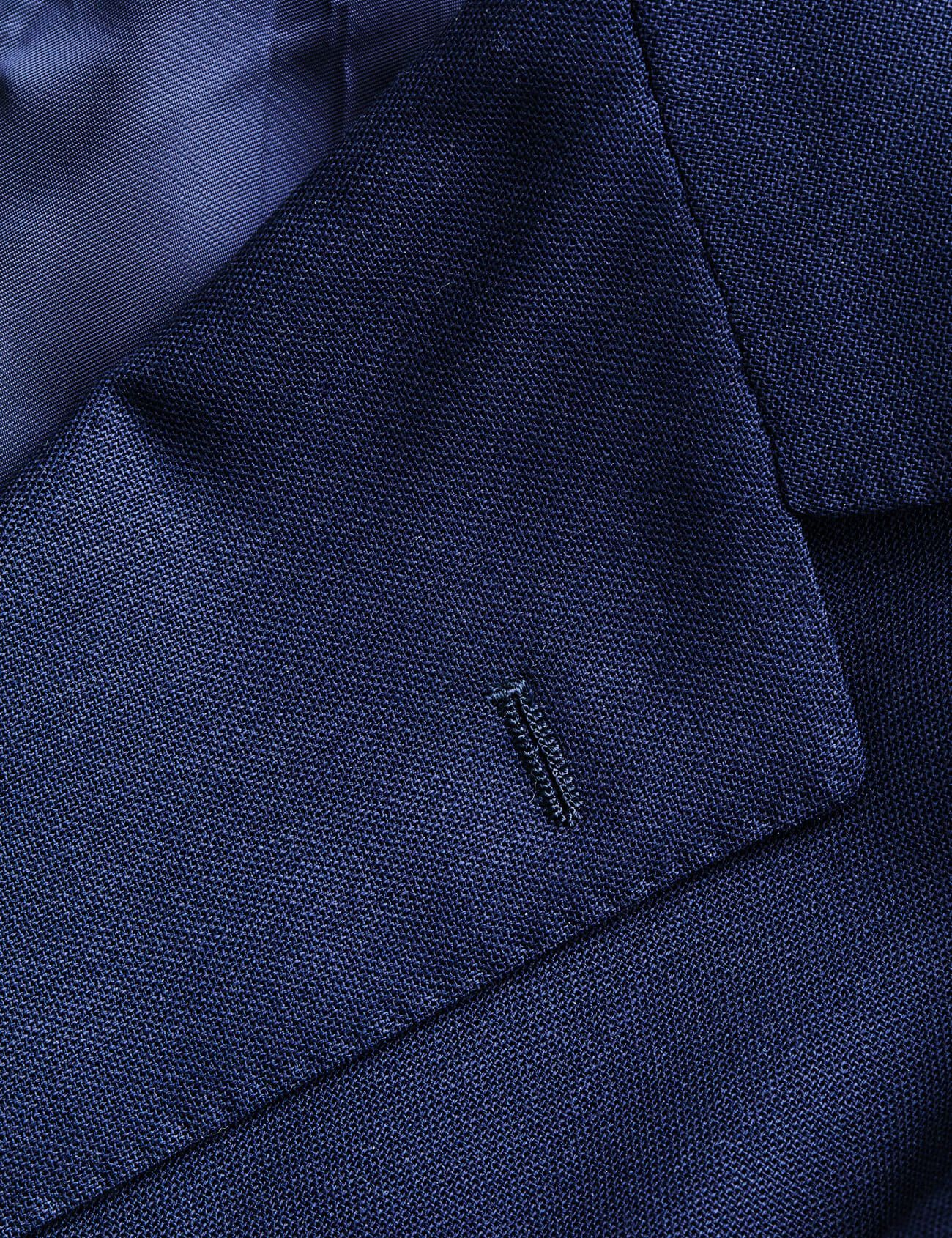 The Real Reason Your Suit Has a Random Buttonhole on the Lapel